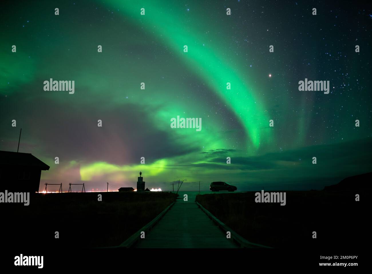A beautiful shot of the Northern Lights over a sea in Vardo, Norway ...