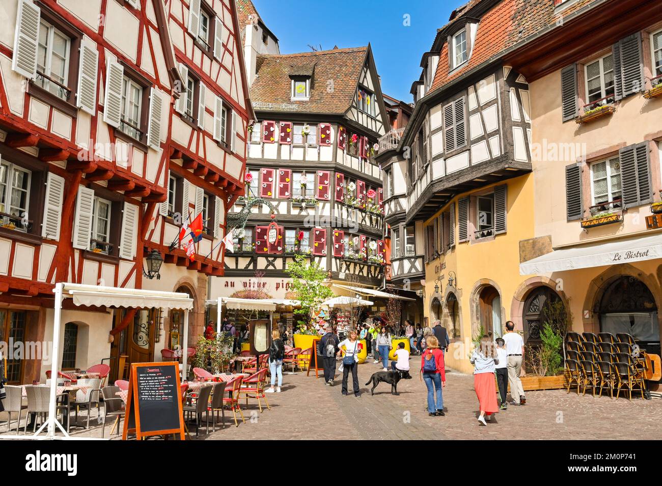 Colmar, France - April 2022: People in one of the narrow streets of old ...