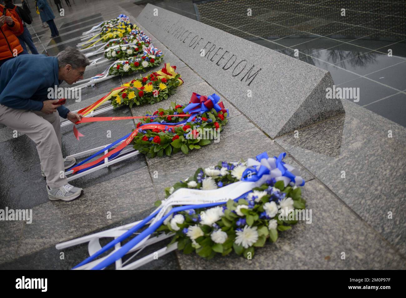 Washington, United States. 07th Dec, 2022. An man adjusts the ribbons ...