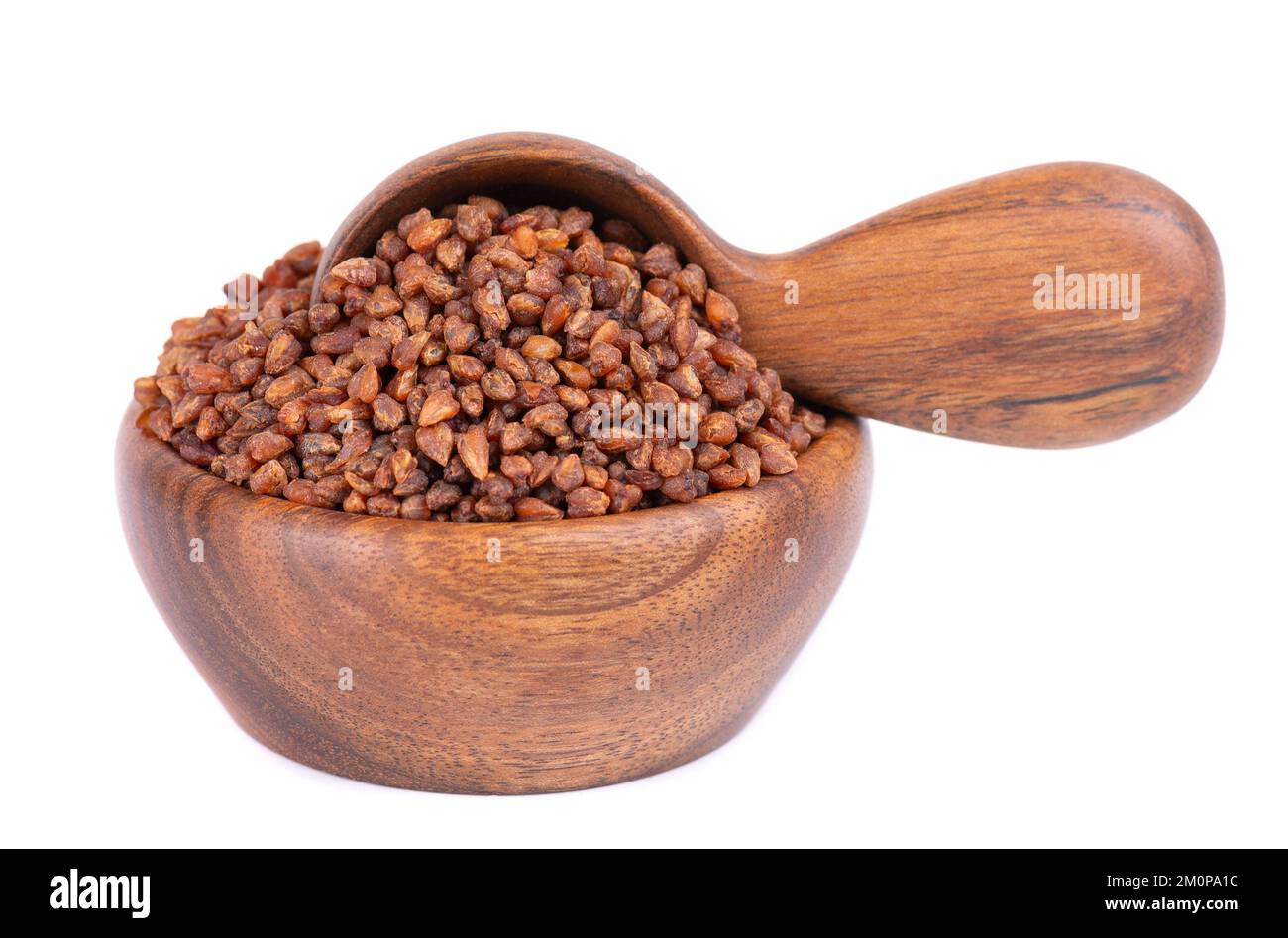 Buckwheat tea in wooden bowl and spoon, isolated on white background ...