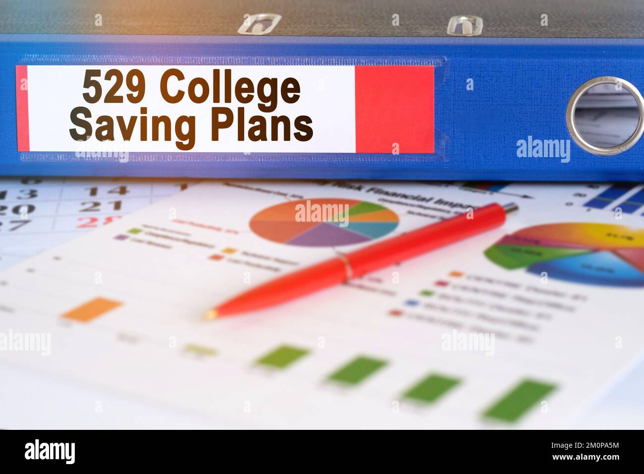On the table are pie charts, a pen and a folder with the inscription - 529 College Saving Plans ...