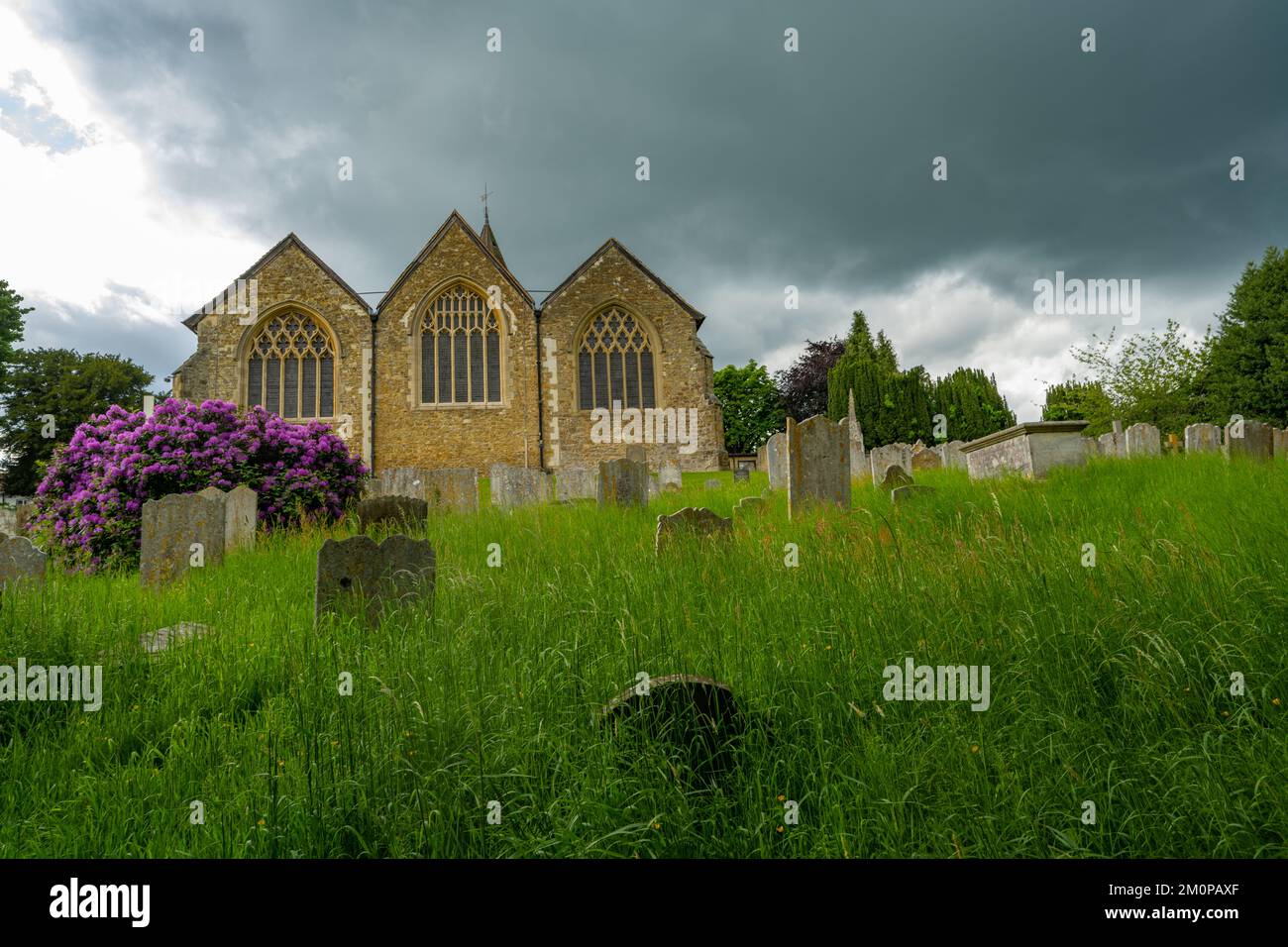 The church of St Mary. The Virgin at Westerham Kent. With storm clouds ...