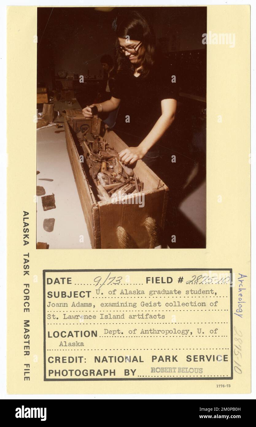 U of Alaska graduate student, Joann Adams, examining Geist collection ...
