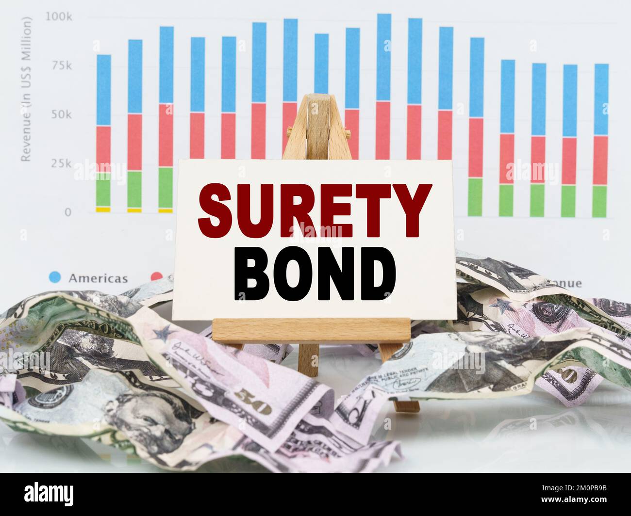 Business and finance concept. Among financial charts and money is a ...