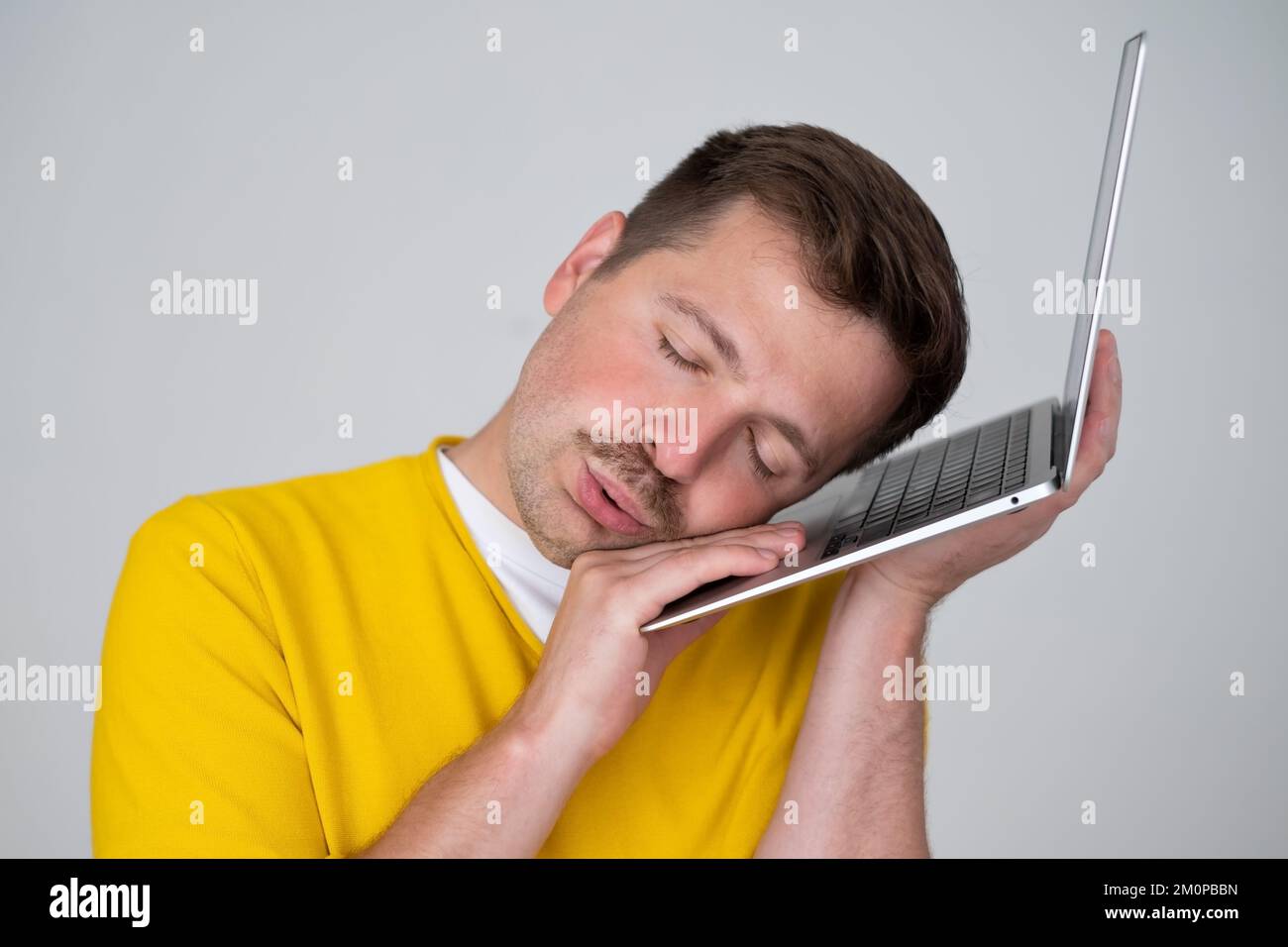 Tired caucasian man sleeping on a laptop having a nap time Stock Photo ...