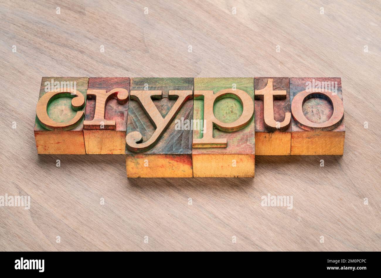 crypto - word abstract in letterpress wood type against grained wooden background, digital money ...