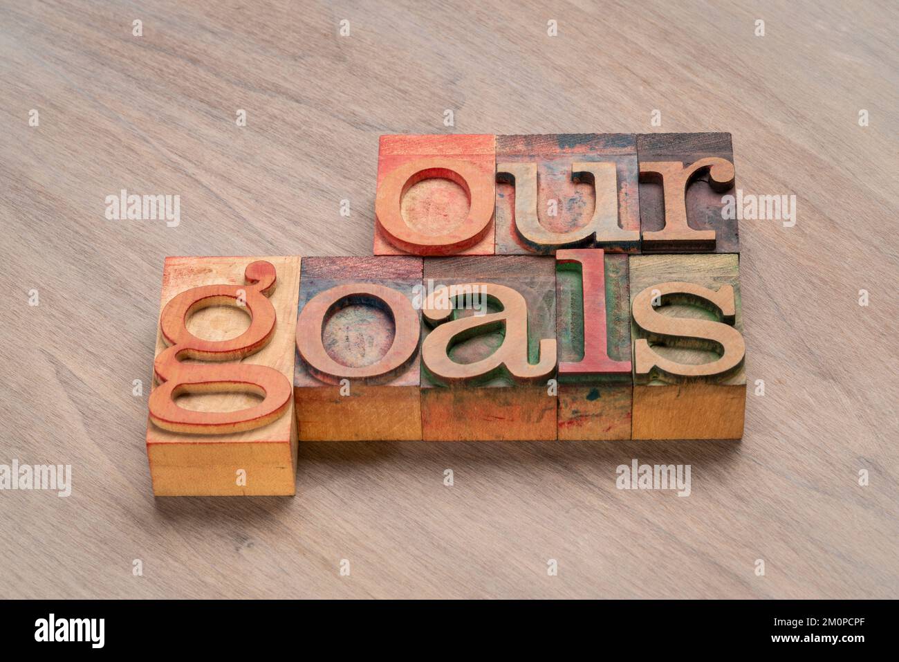 our goals - word abstract in letterpress wood type against grained ...