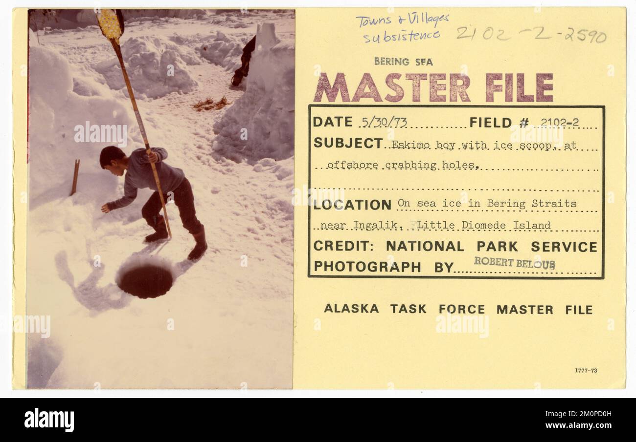 Eskimo boy with ice scoop at offshore crabbing holes. Alaska Task Force ...
