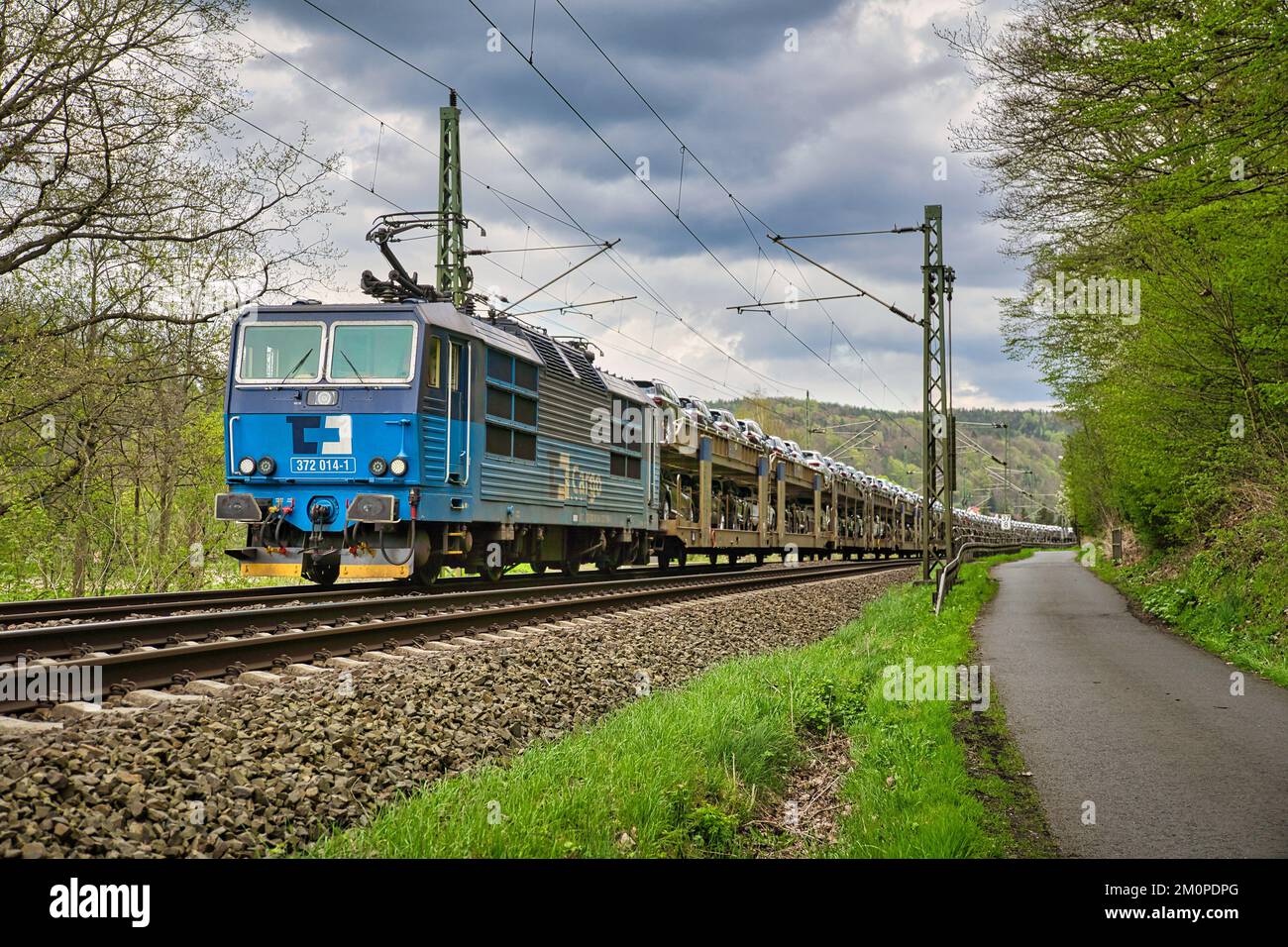 A freight train with car transport wagons through the city of Wehlen by ...