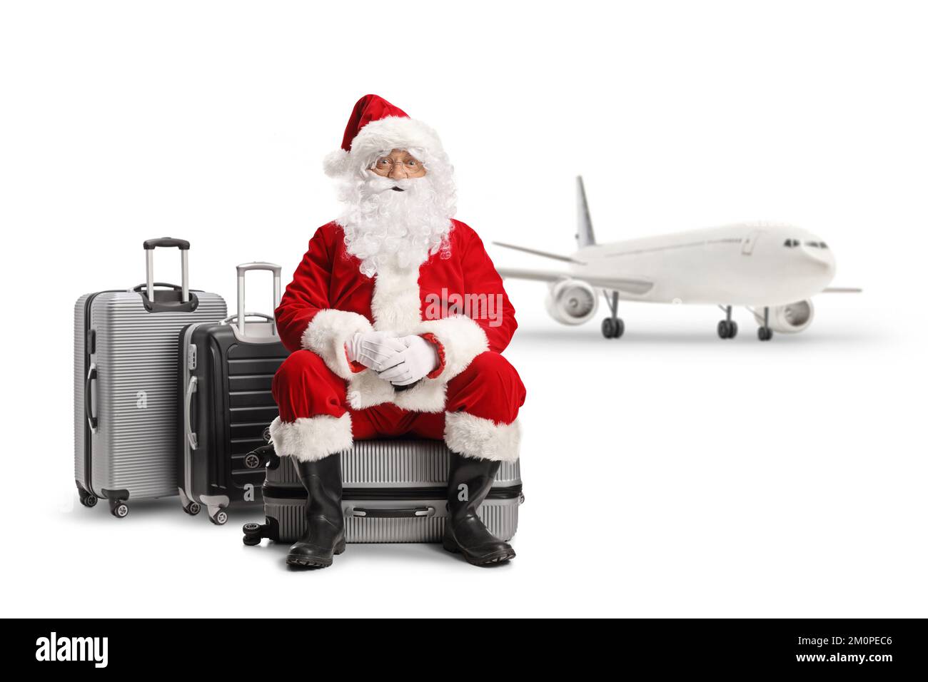 Santa claus sitting on a suitcase at an airport and waiting for a plane ...