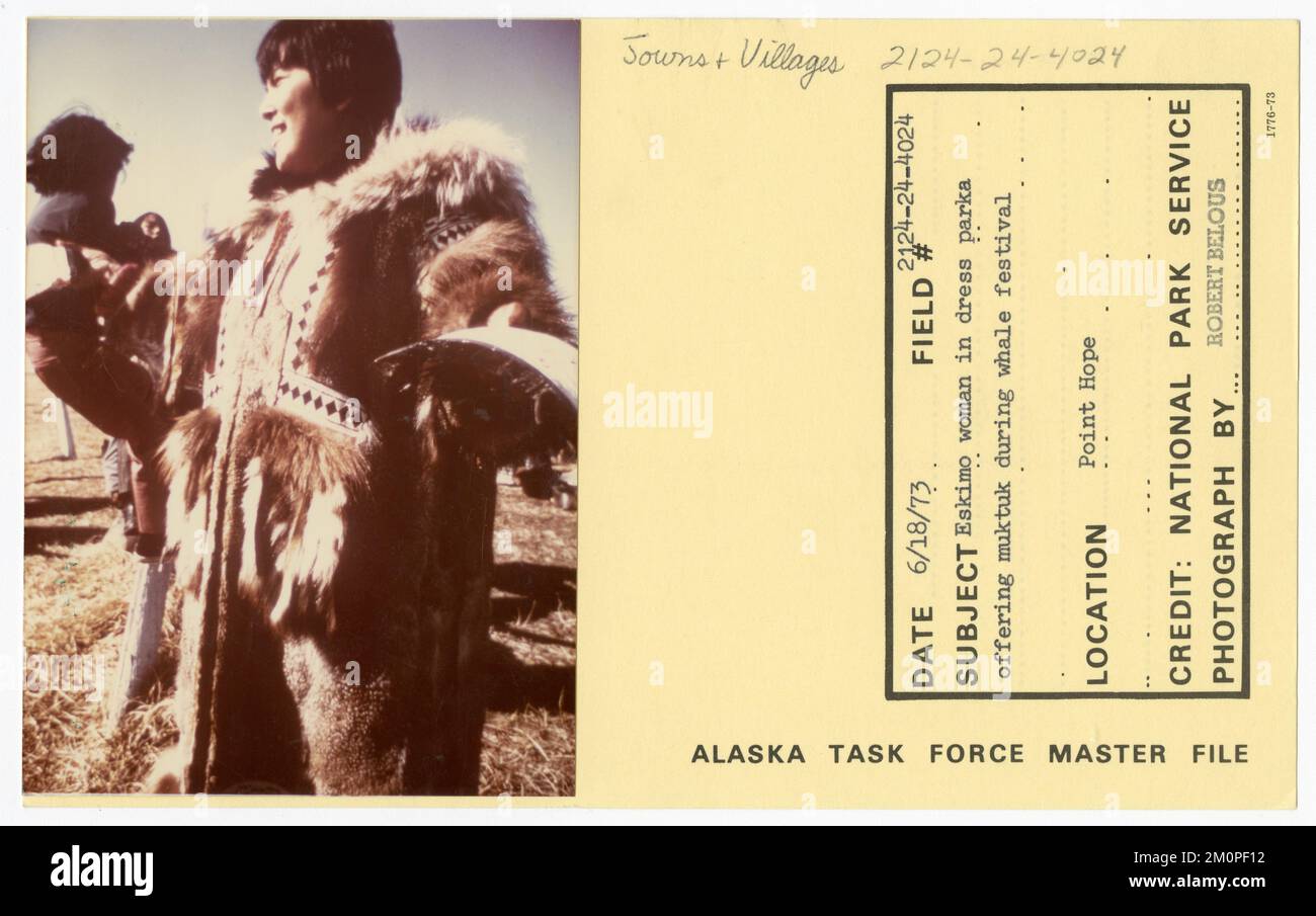 Eskimo woman in dress parka offering muktuk during whale festival ...