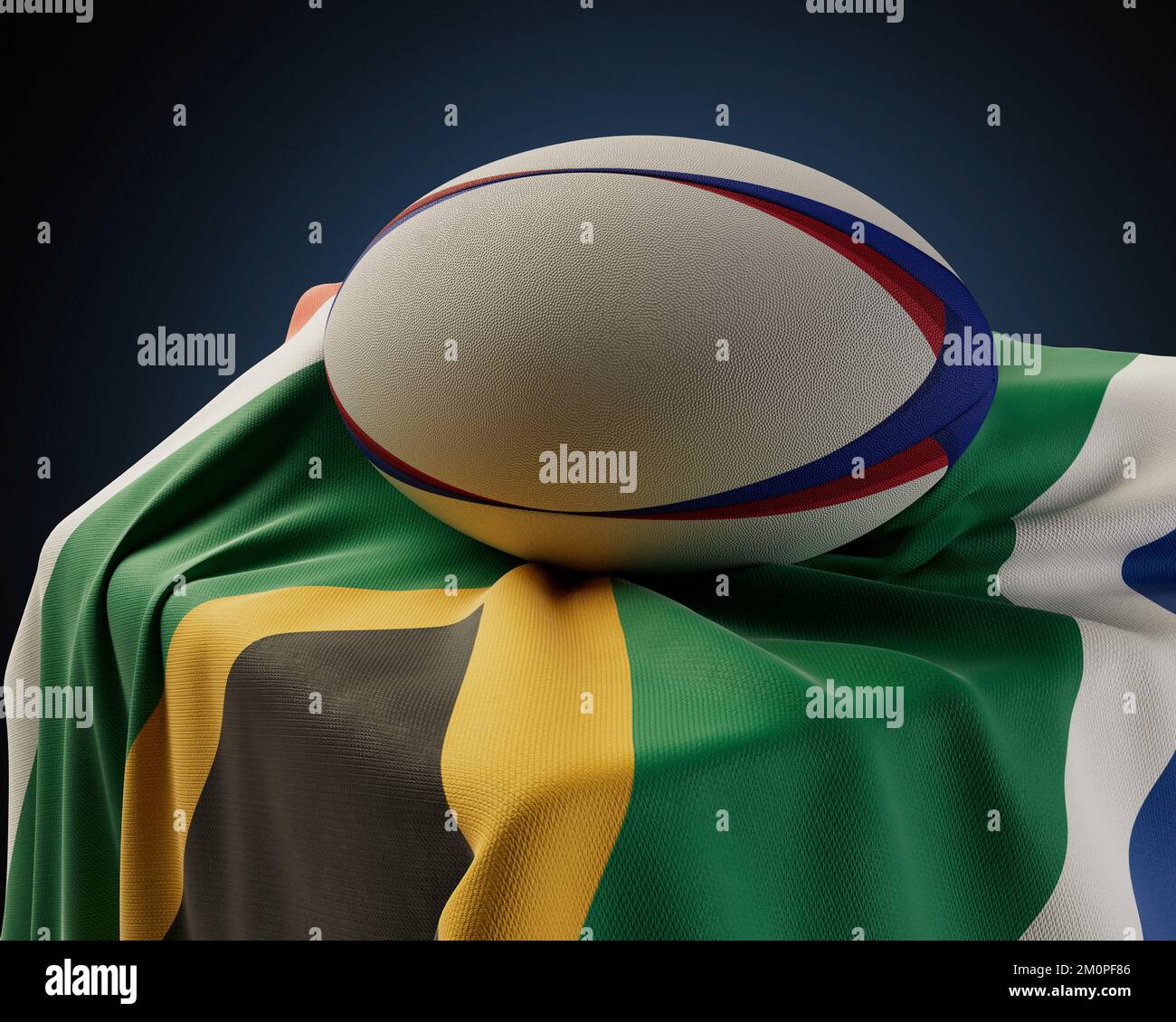 A regular rugby ball resting on a South Africa flag draped over a ...