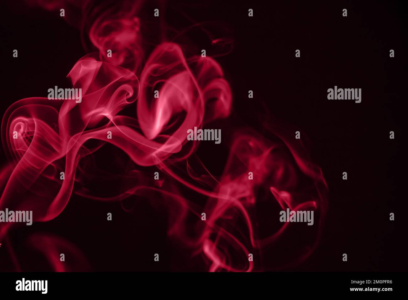 Red puffs of smoke on a black background. Color of the year 2023 - Viva ...