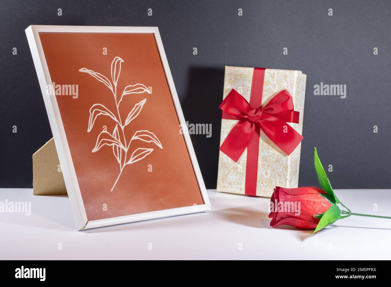 A closeup of a small jewellery gift box with an artificial rose and a ...