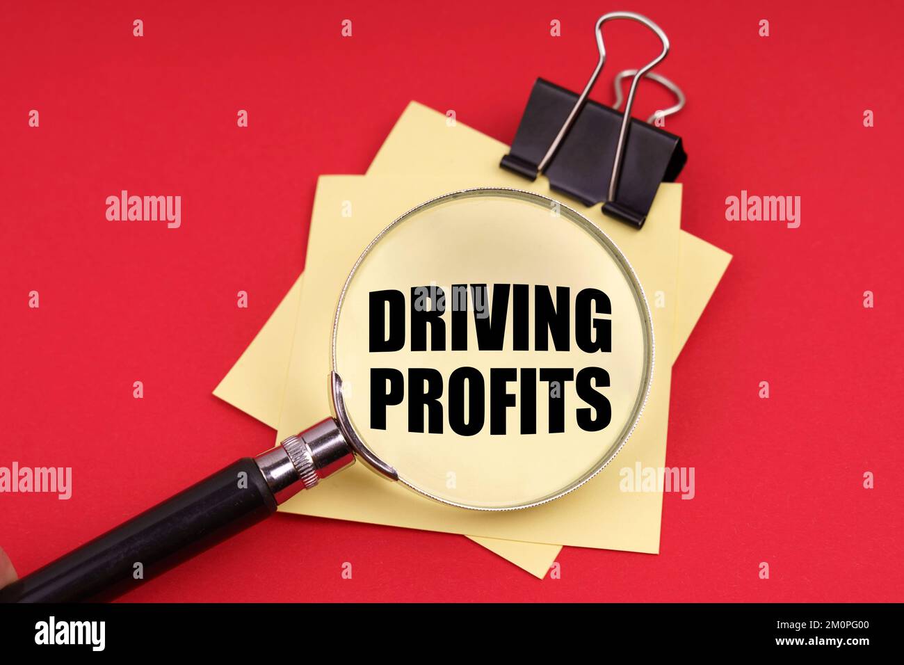 Business and Economics. On a red background, a magnifying glass and a ...