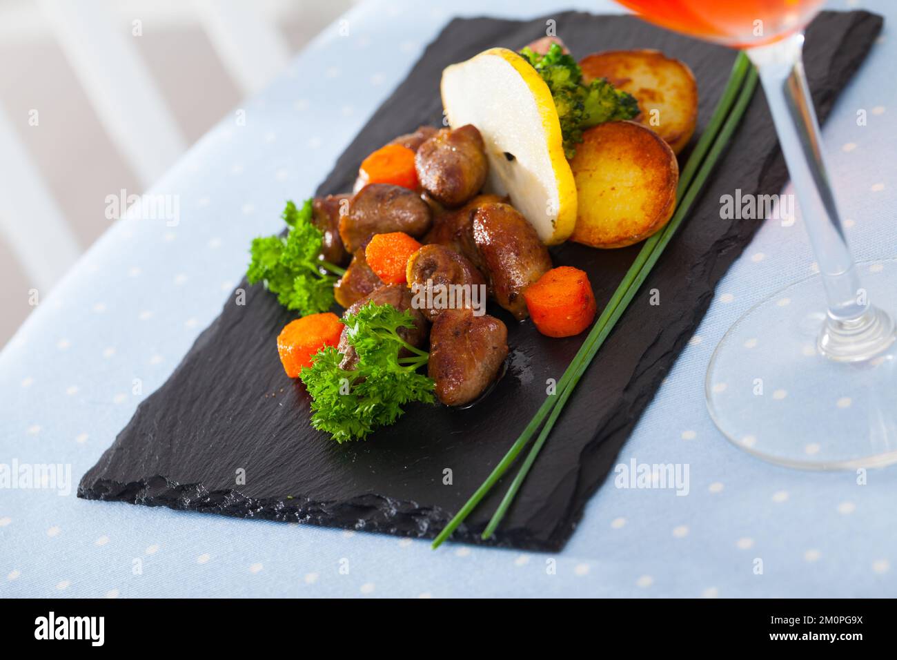 Delicious fried chicken hearts served with baked vegetables and fresh ...
