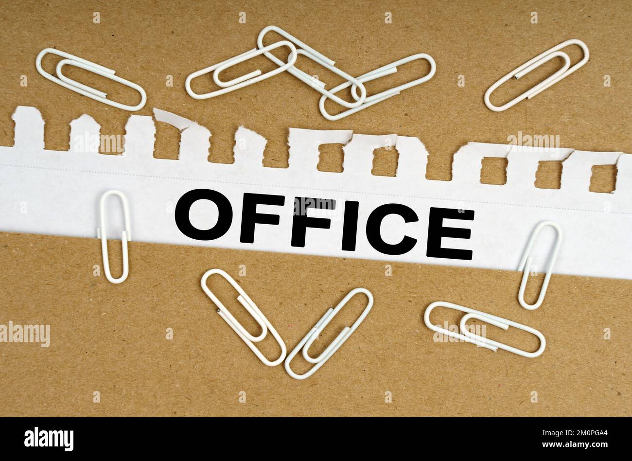 Business concept. On cardboard, white paper clips and a sheet from a ...