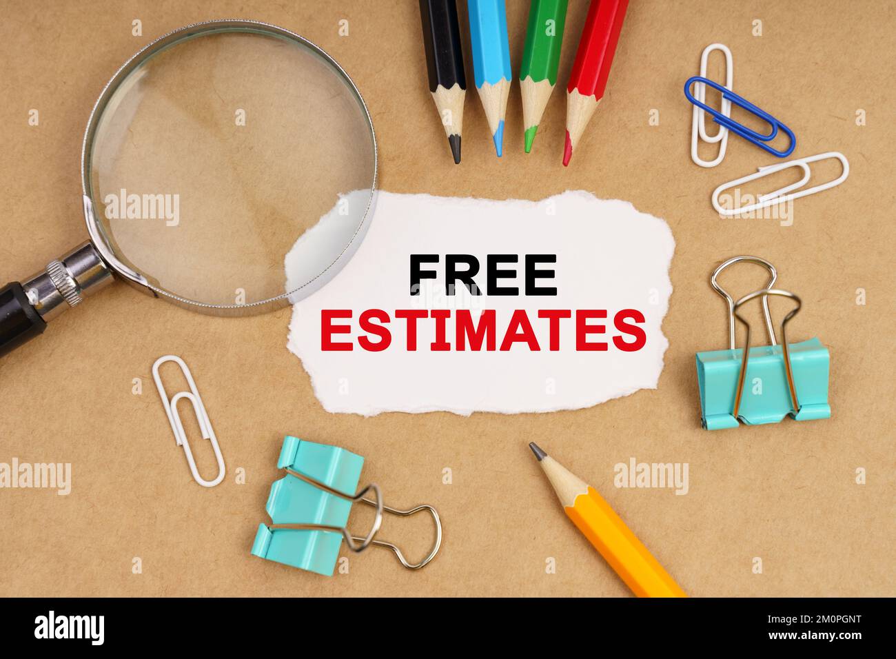 Business concept. On the table are pencils, paper clips, a magnifying ...