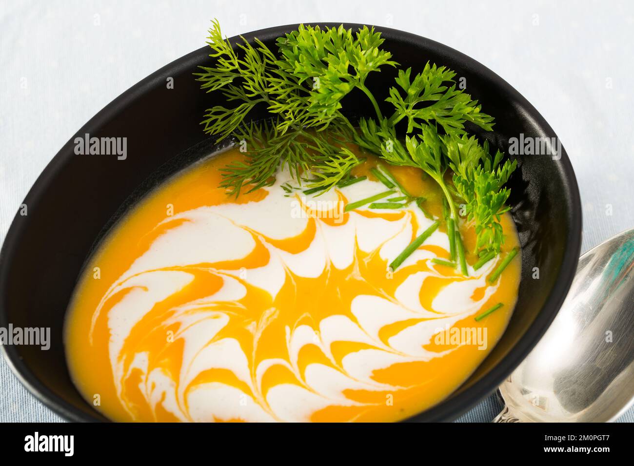Tasty homemade rustic pumpkin and ginger soup puree in ceramic bowl ...