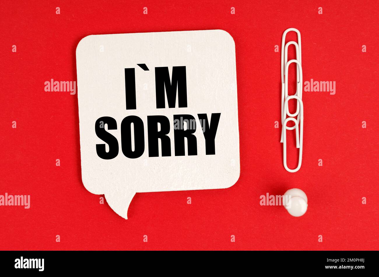 Business concept. On a red background, paper clips are an exclamation ...