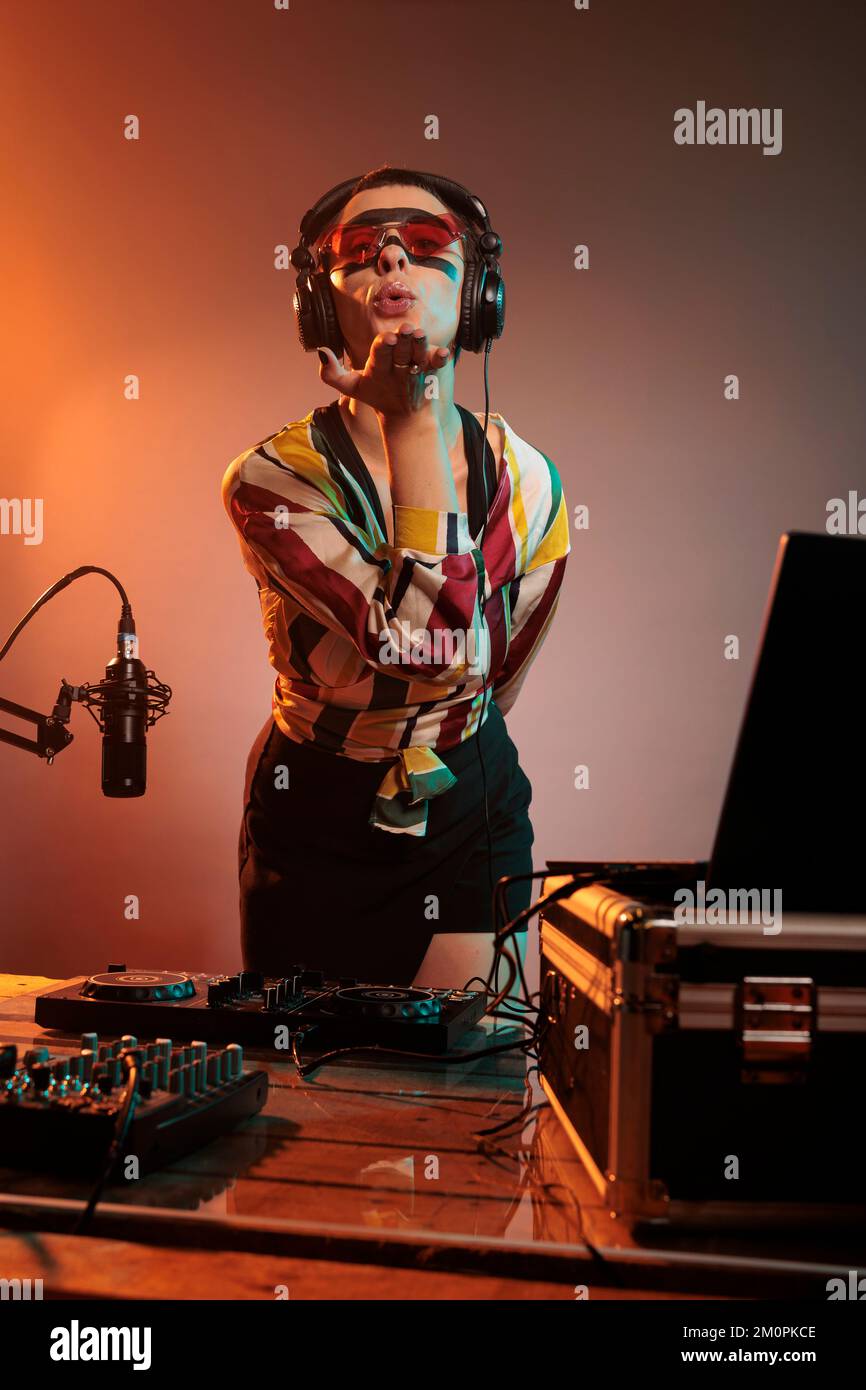 Woman DJ blowing air kisses in studio, being romantic and acting flirty ...