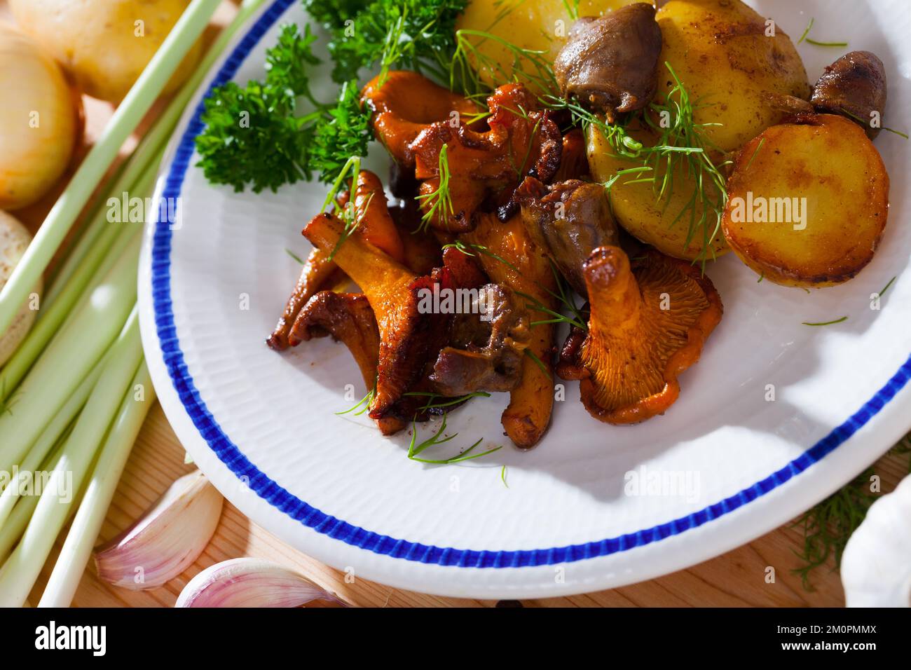 Top view of tasty fried chicken hearts, fried chanterelle mushrooms ...