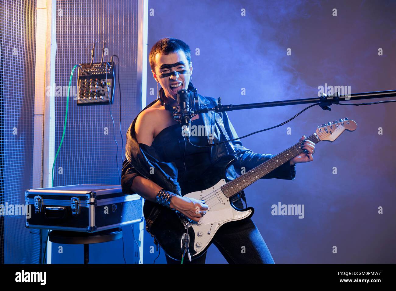 Modern performer girl screaming loud and singing alternative rock music ...