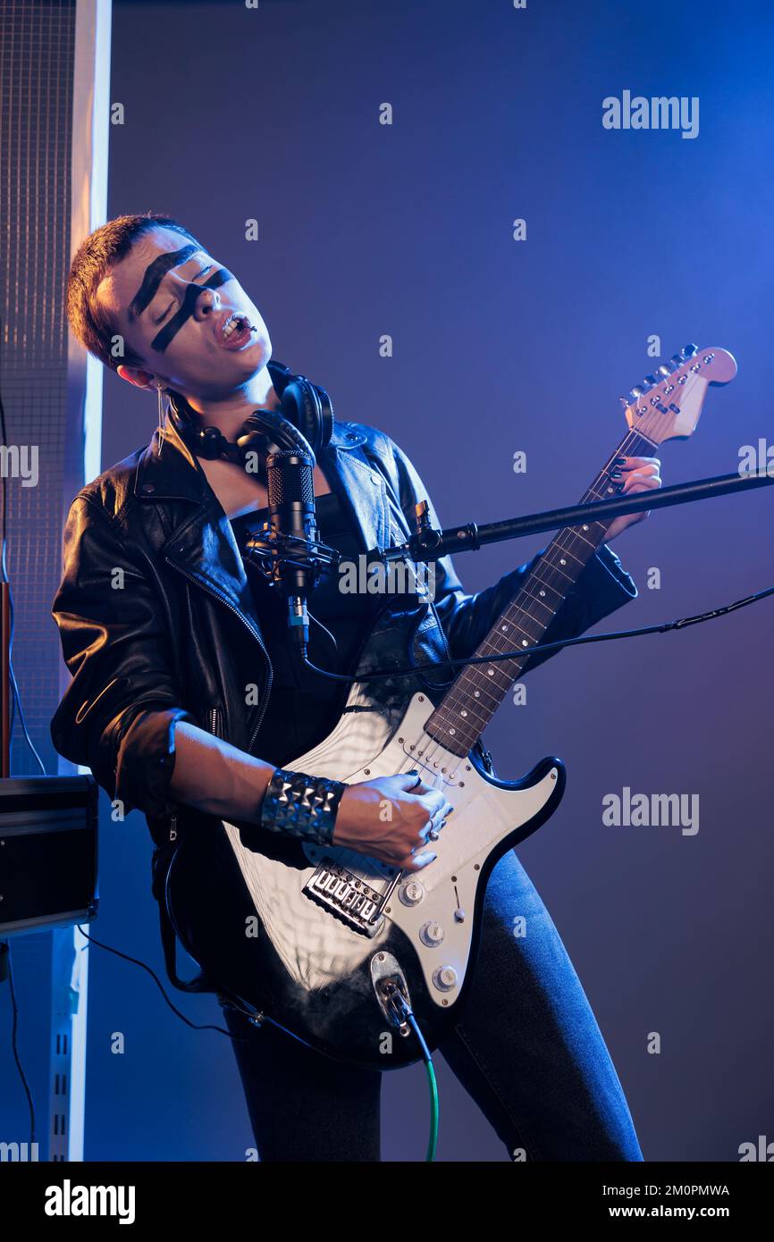Rock star performing live show playing guitar, feeling heavy metal ...