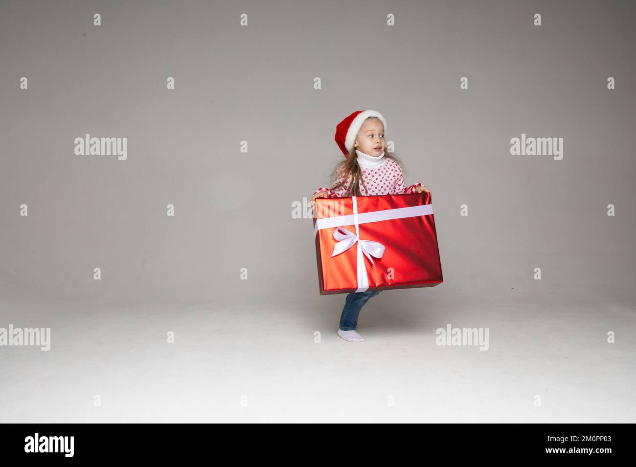 Child having fun with Christmas present. Studio photo Stock Photo - Alamy