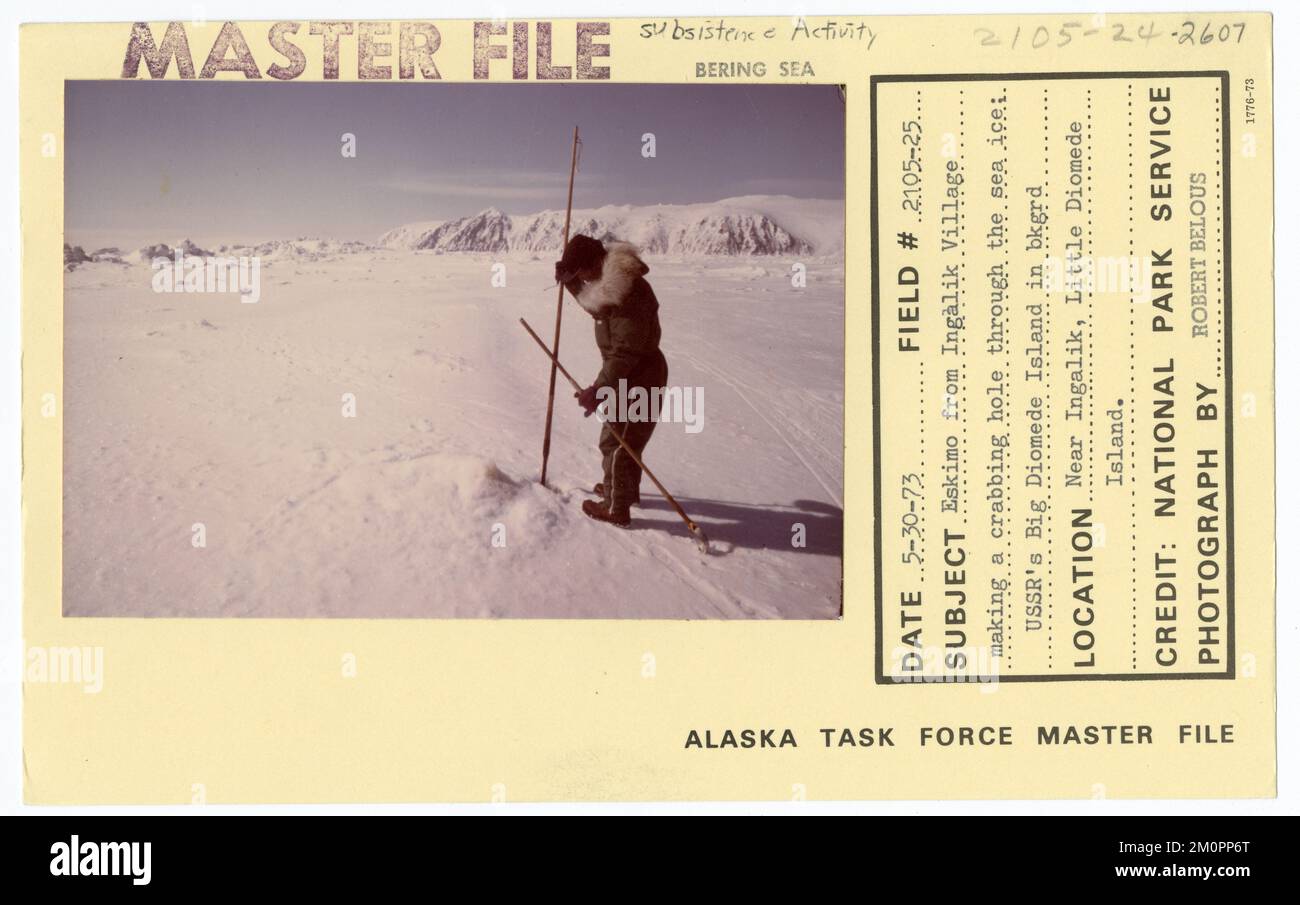 Eskimo from Ingalik Village making a crabbing hole through the sea ice ...