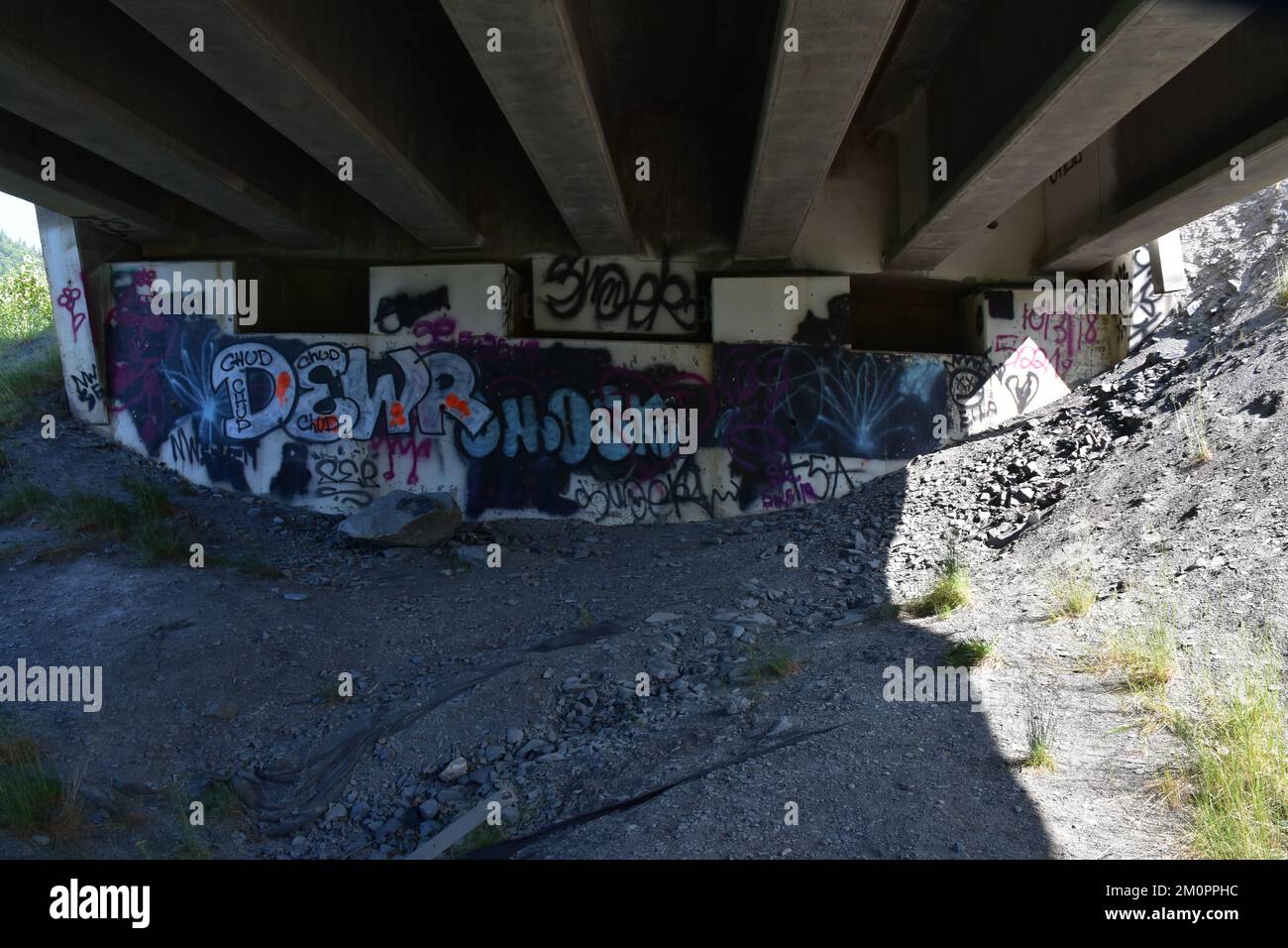 Bridge graffiti with shade and sun Stock Photo - Alamy
