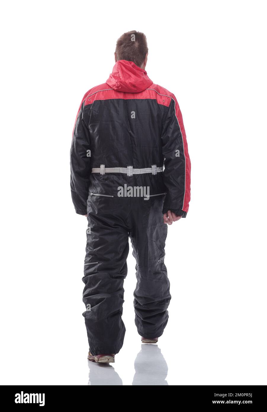 man in a winter insulated jumpsuit reading walking forward Stock Photo ...