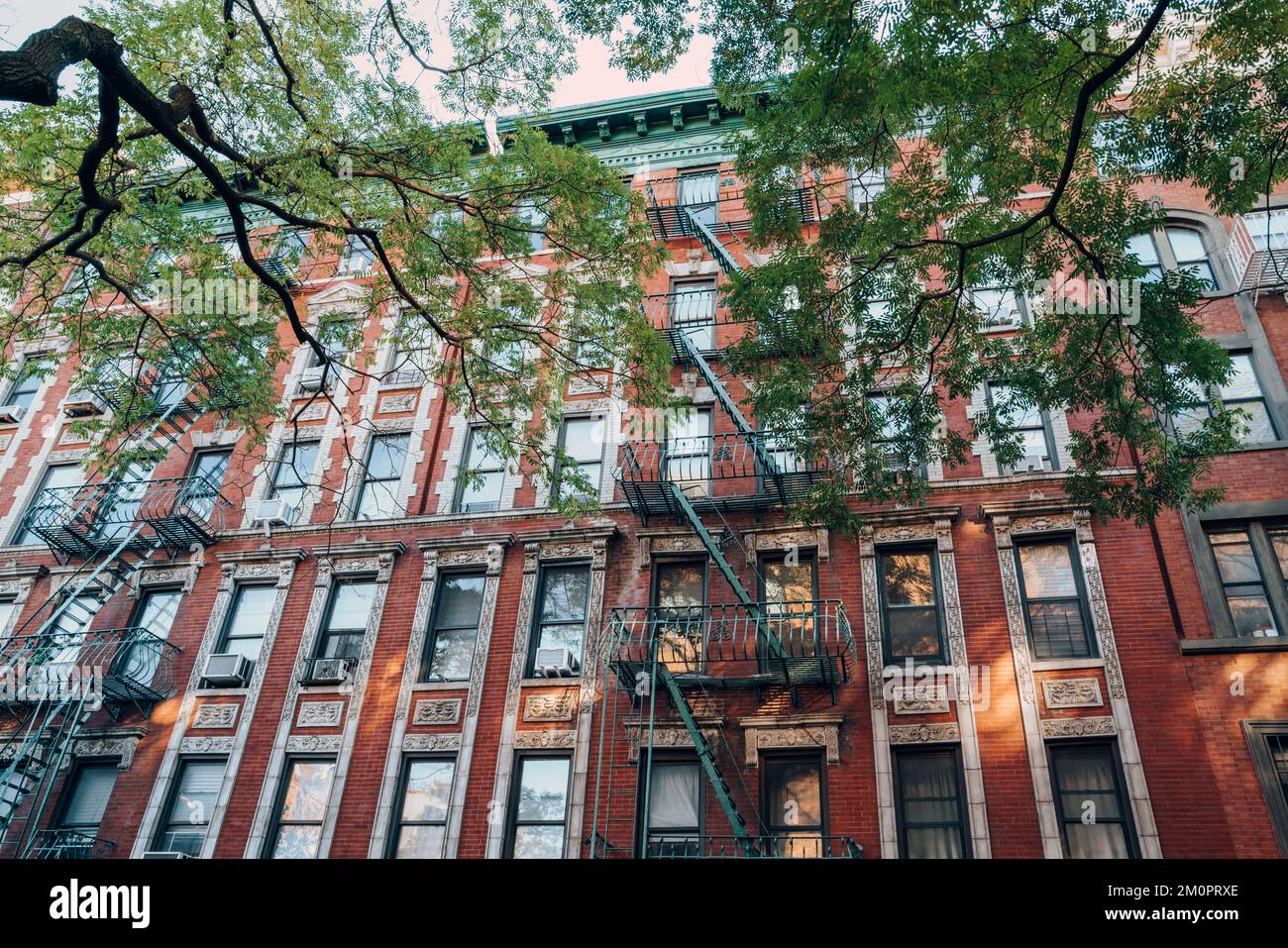 Facade of a typical New York block of flats with fire escape at the ...
