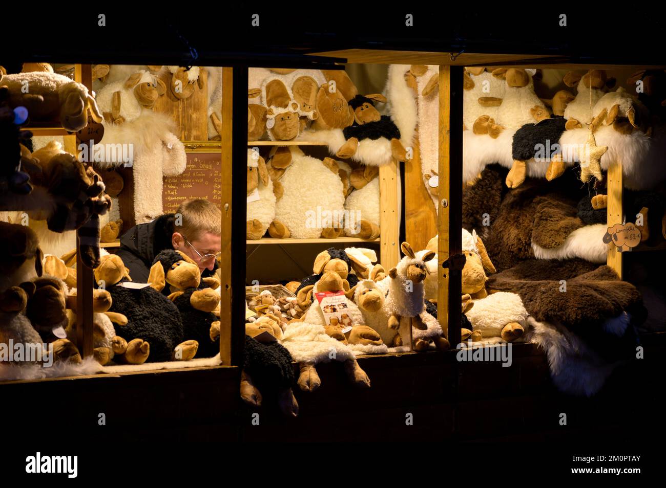 BONN, GERMANY - DECEMBER 6, 2022: Man inside a market stall selling ...