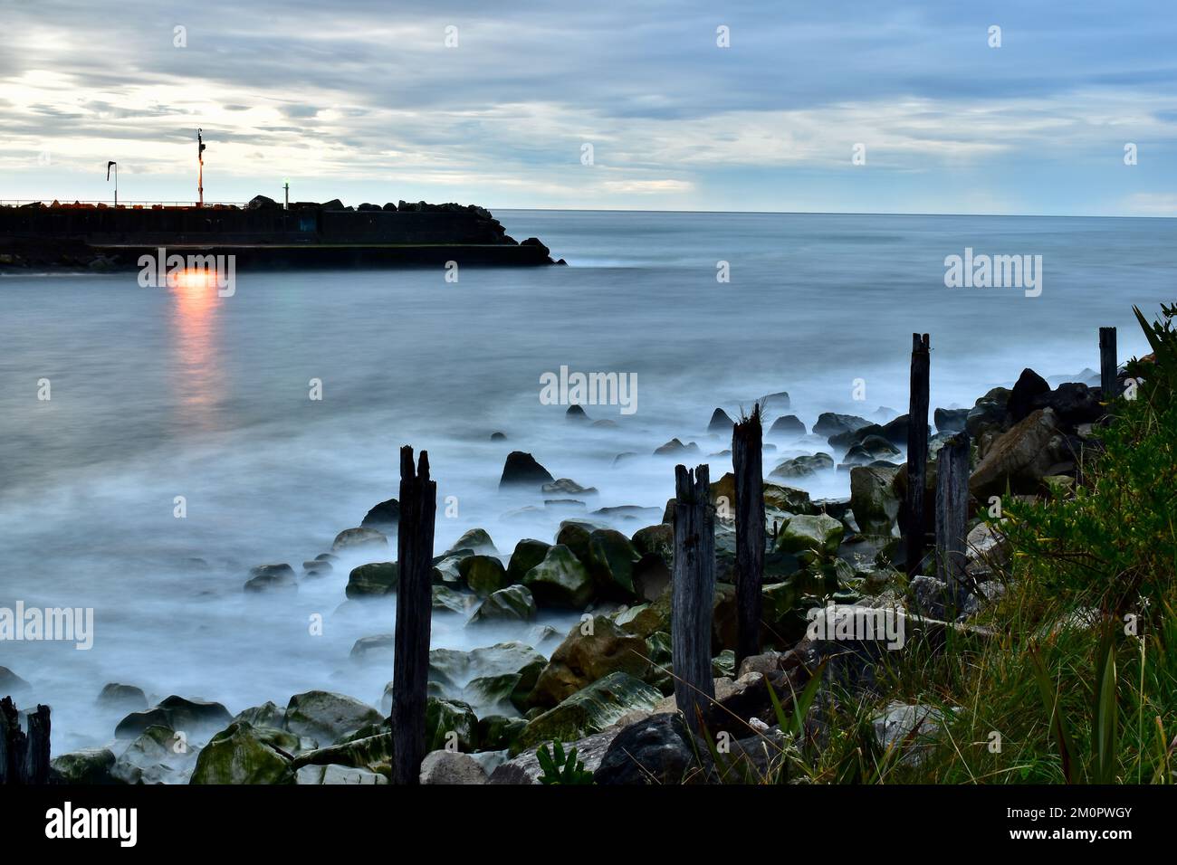 long exposure photograph taken from a sea breakwater where the river ...