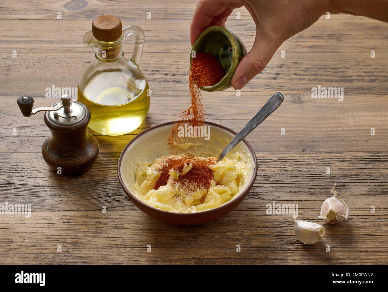 adding paprika powder to garlic butter. process of making roasted ...