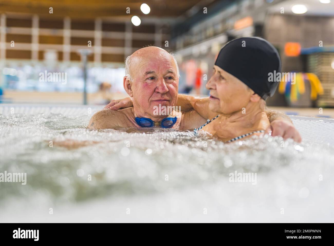 Senior caucasian married couple with swimming pool equipment - hair cap ...