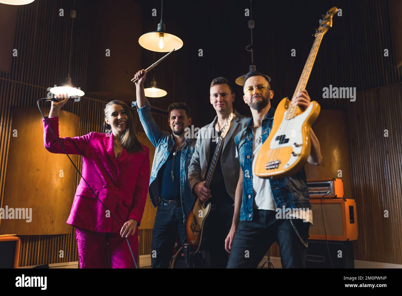 Music band posing together in a rehearsal studio. High quality photo ...