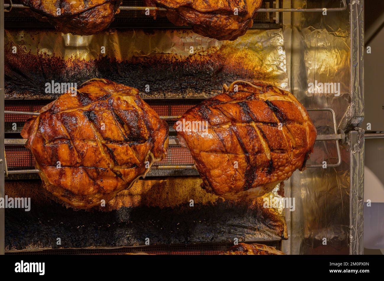 BONN, GERMANY - DECEMBER 6, 2022: CLoseup of Prague ham being roasted ...