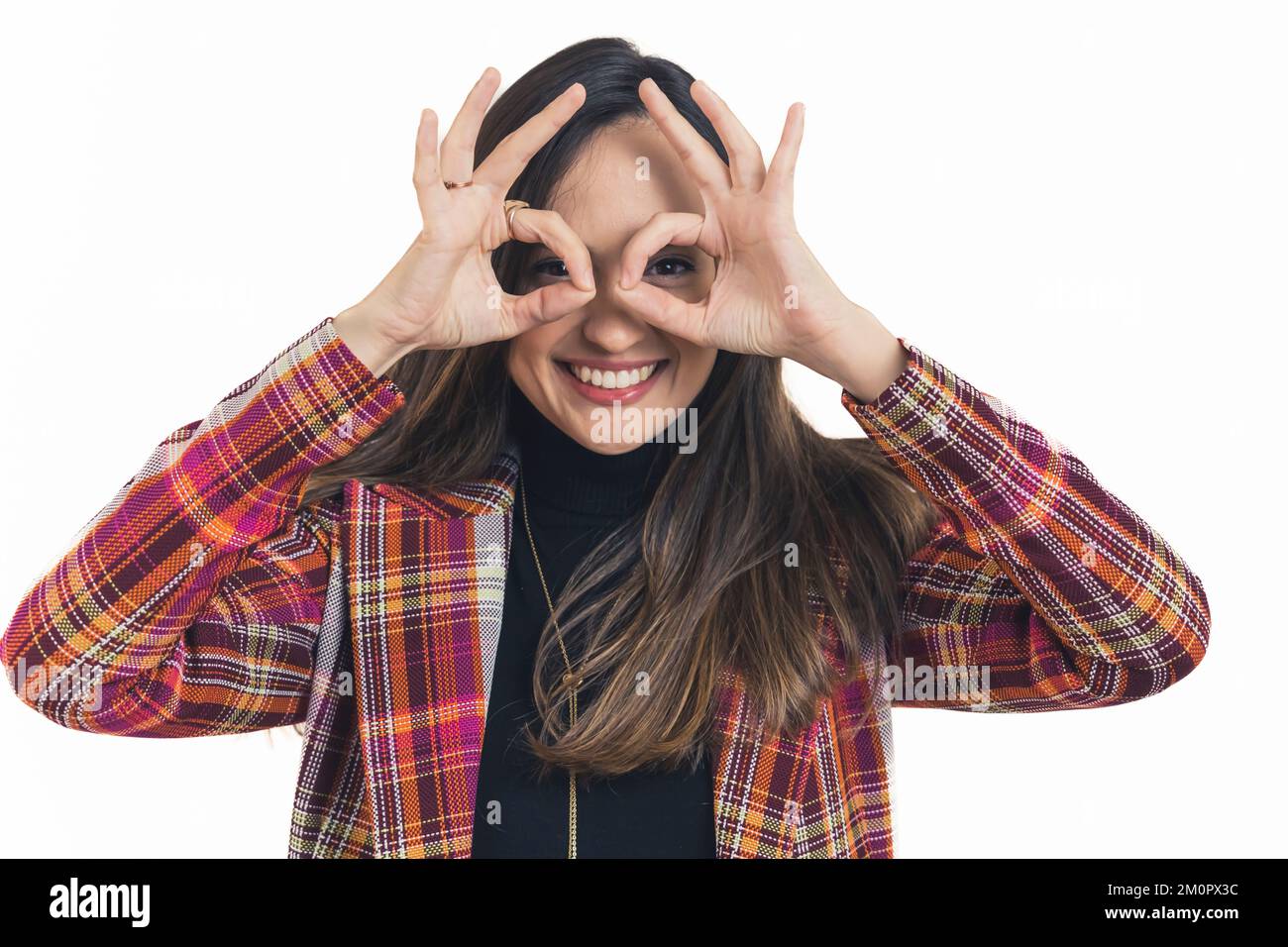 Portrait of a happy young woman making circles using her hands around ...