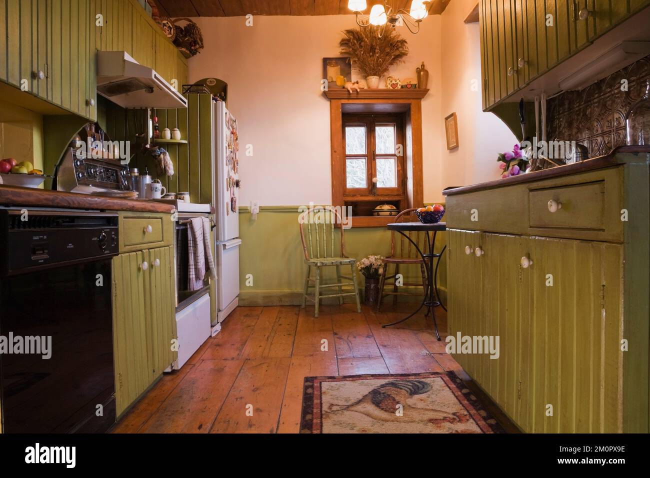 Kitchen room with olive green cabinets inside old 1850 Canadiana ...