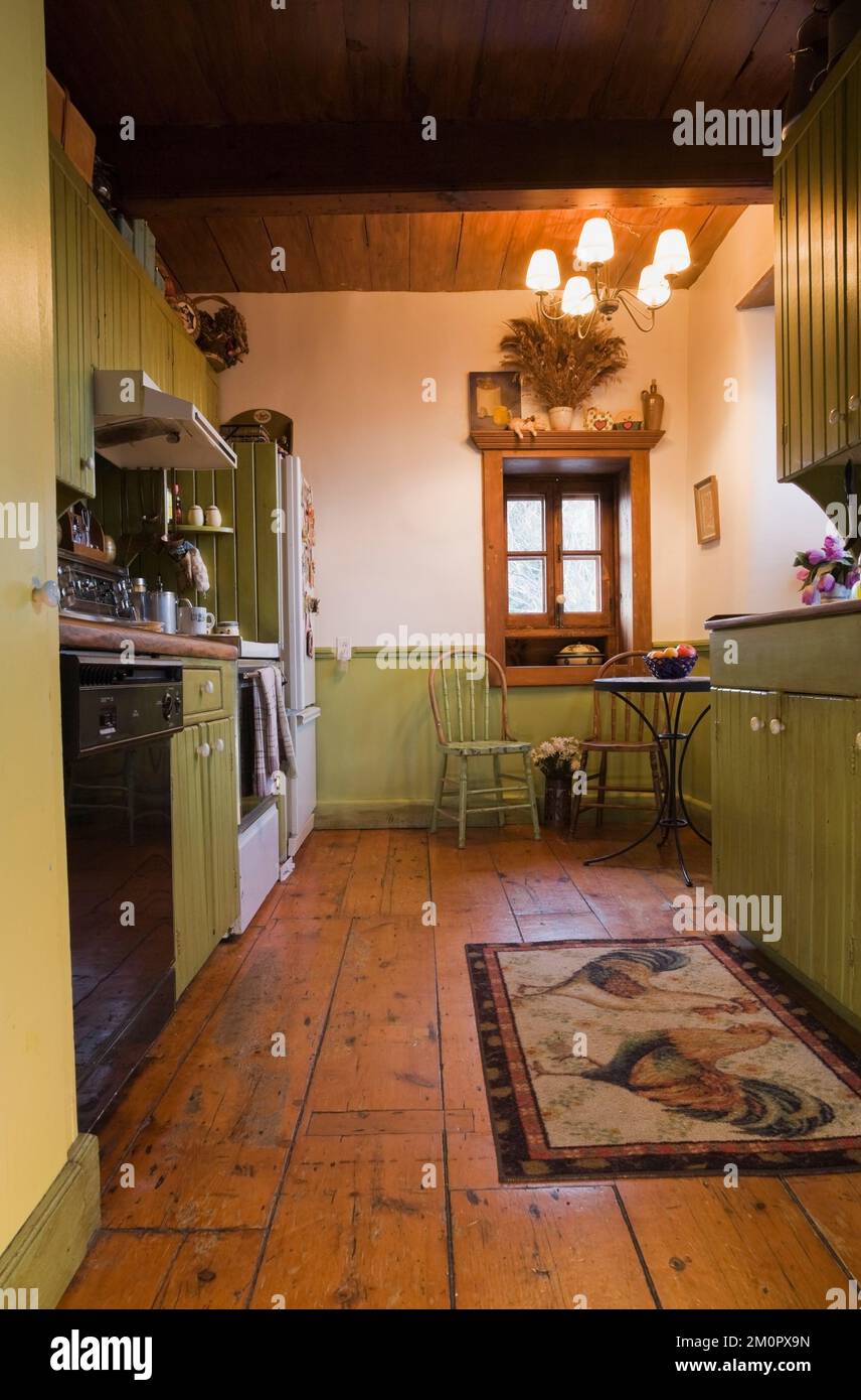 Kitchen room with olive green cabinets inside old 1850 Canadiana ...