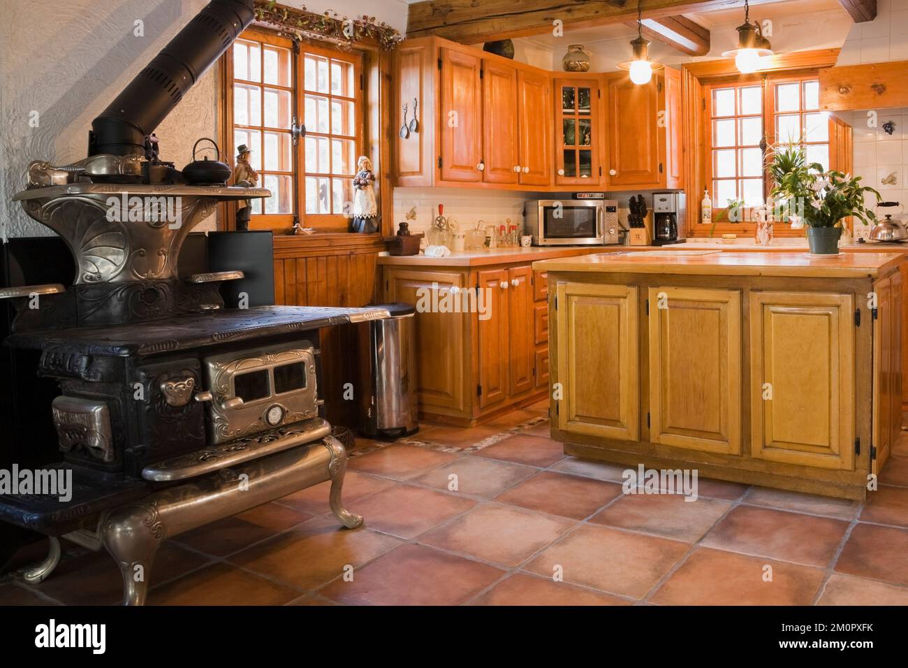 1919 Happy Thought wood burning stove and wooden cupboards in kitchen ...