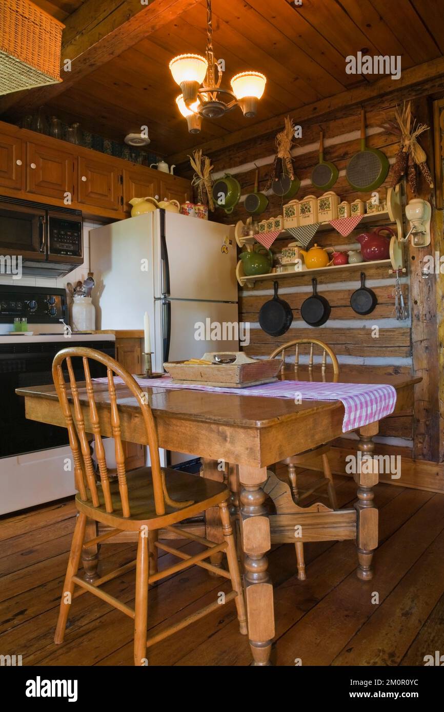 Square table and rounded high back chairs in rustic kitchen inside 1977 ...