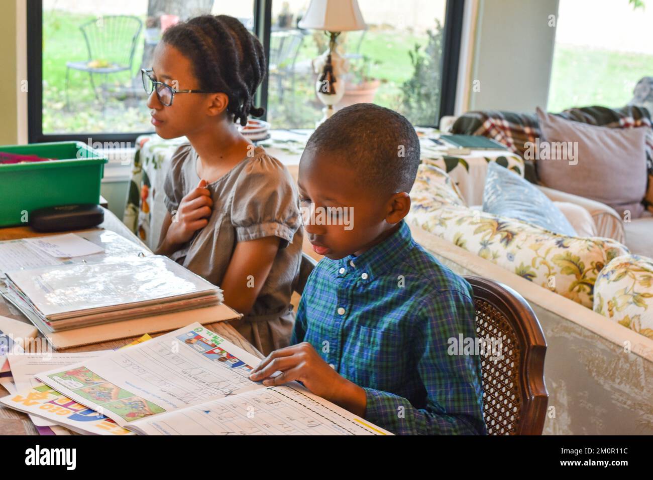 Kids sitting at kitchen table doing homework hi-res stock photography ...