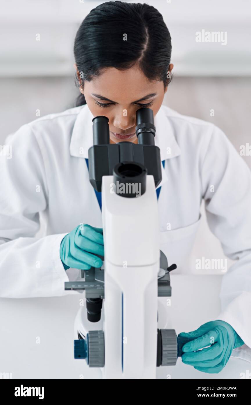 Lets see what we have here...an attractive young female scientist looking through a microscope ...
