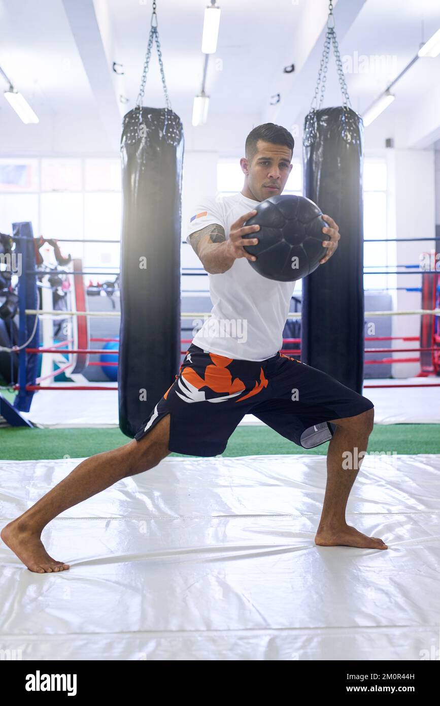 Core strength is an important part of boxing. a young man going through ...