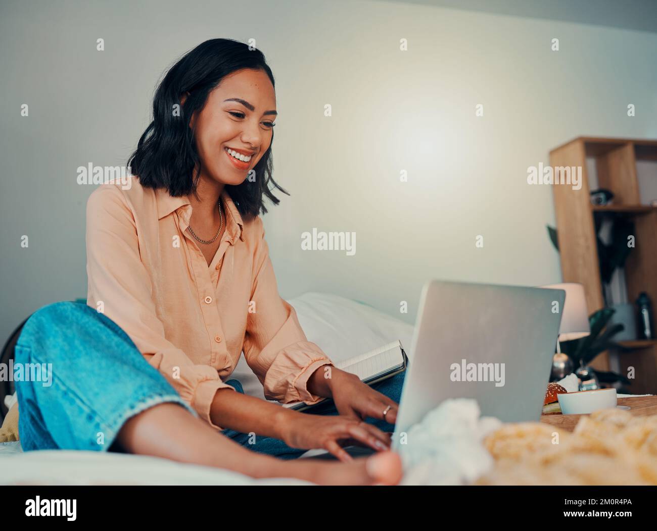 Laptop, bedroom and blogging with a woman on her bed at home, reading ...