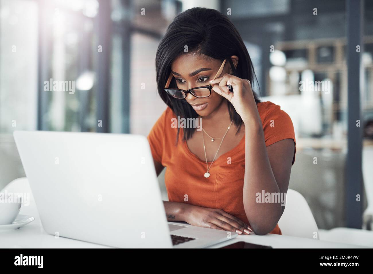 Taking a closer look at things. an attractive young businesswoman ...