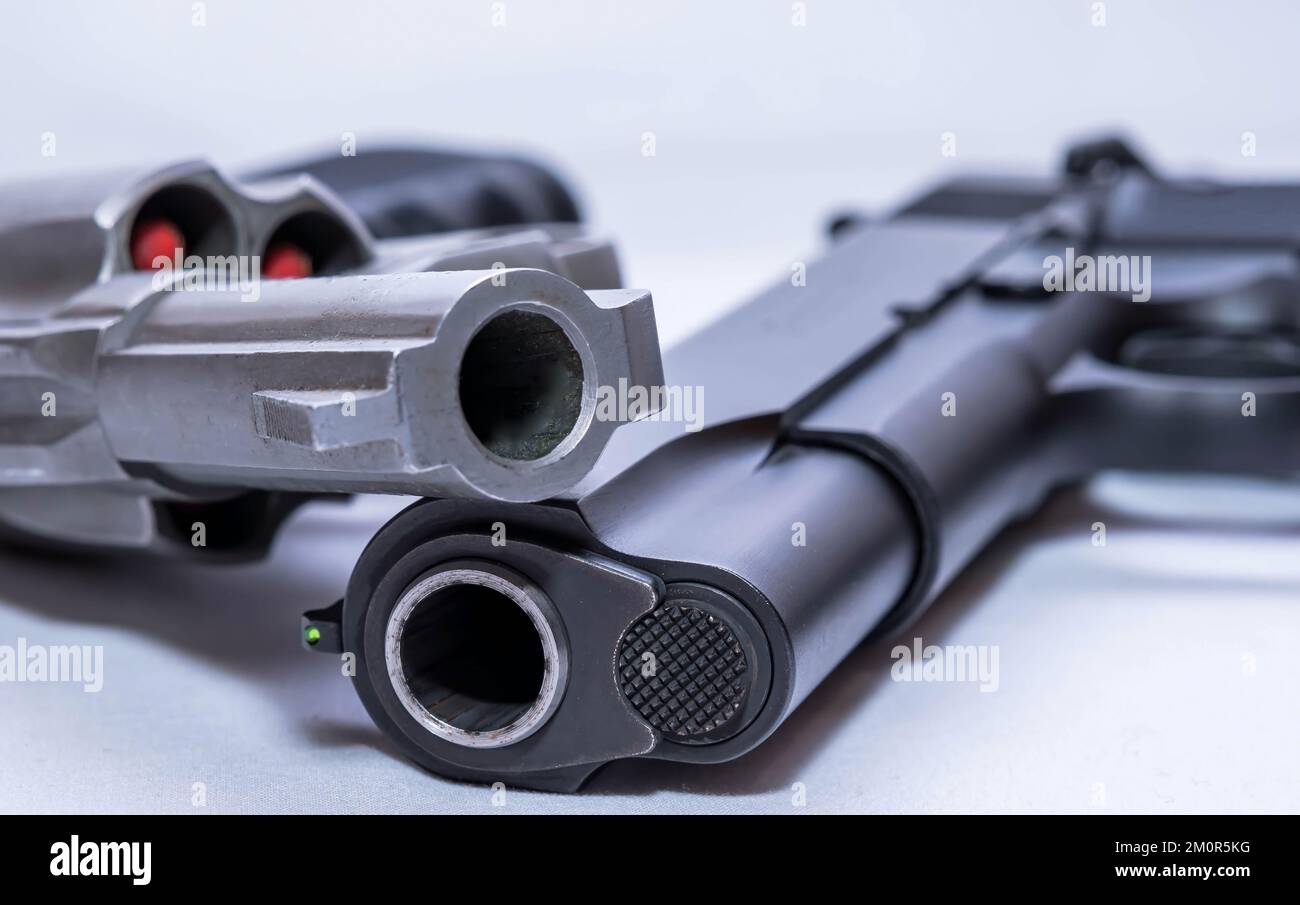 Two handguns, a 45 caliber pistol and a 44 special revolver stacked ...